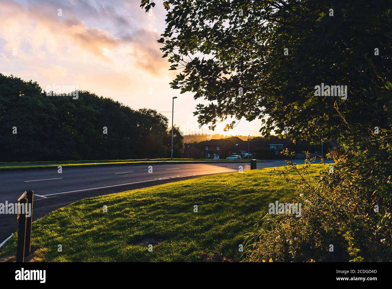 Closeup shot of a beautiful sunset on a road with houses Stock Photo ...