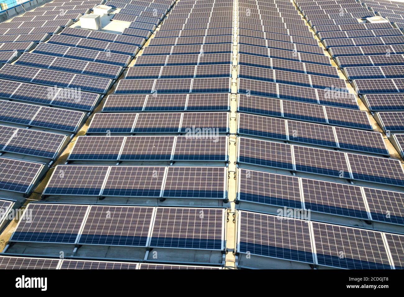 Aerial view of many photo voltaic solar panels mounted of industrial ...