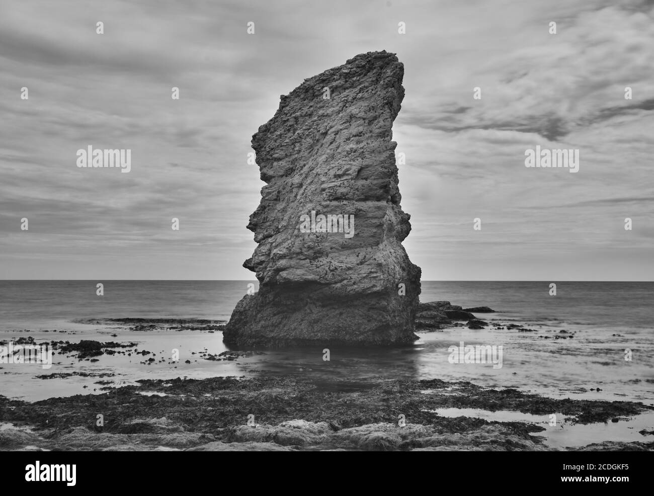 Beautiful grayscale shot of a giant rock in a sea, Dorset AONB ...