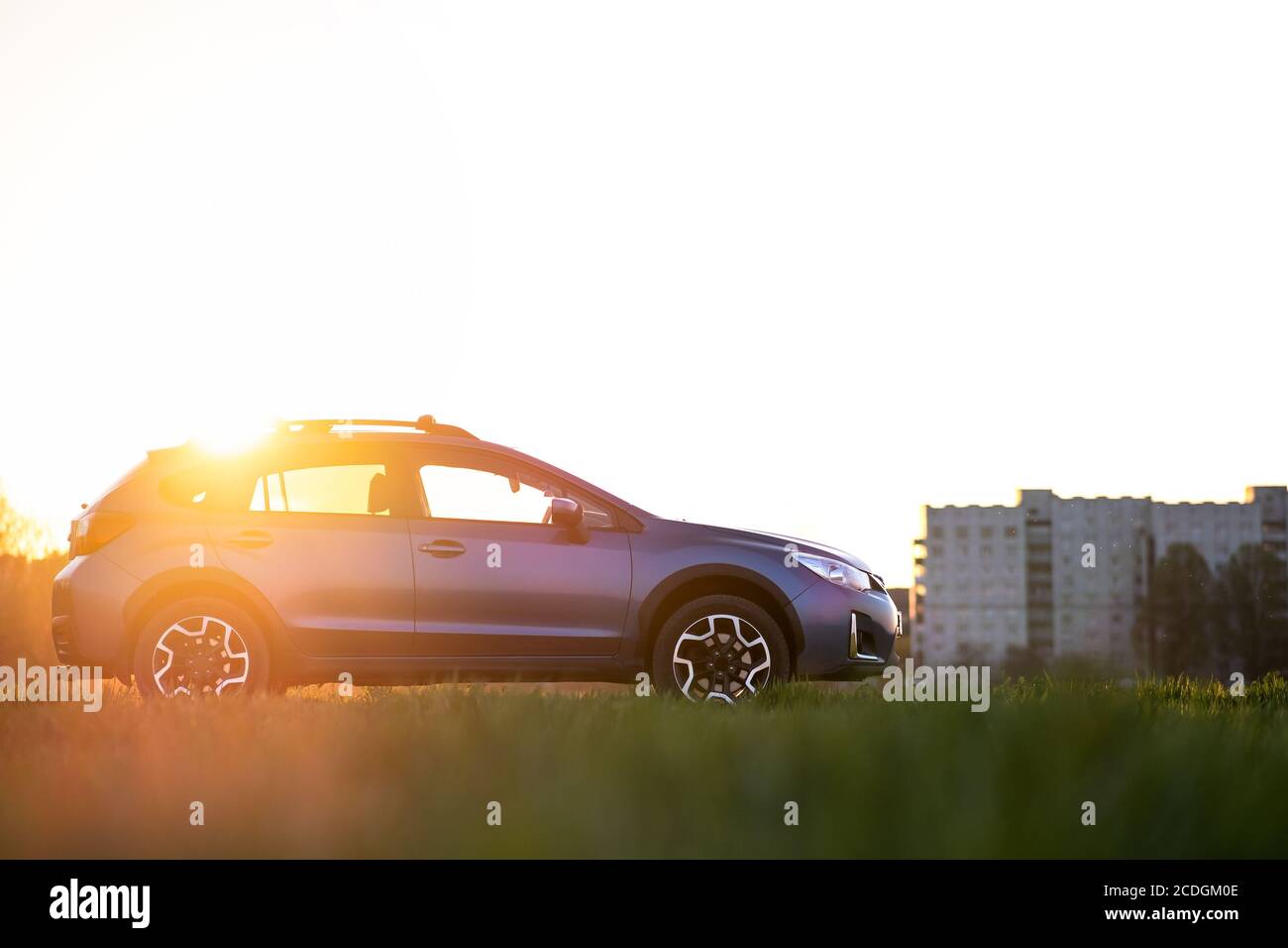 Landscape with blue off road car on green grass at sunset. Traveling by ...
