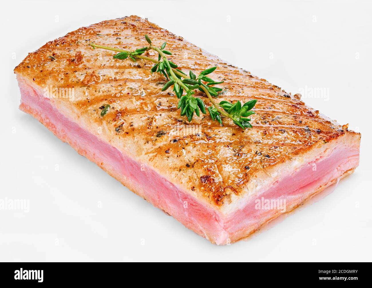 Juicy cooked tuna fish fillet grilled with green herbs close-up ...
