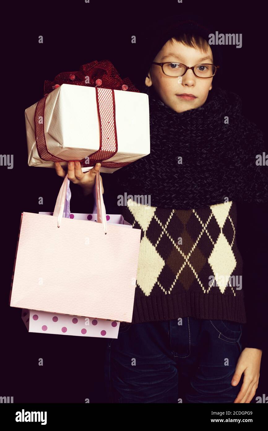 small boy or cute nerd kid in glasses, hat and fashionable knitted ...