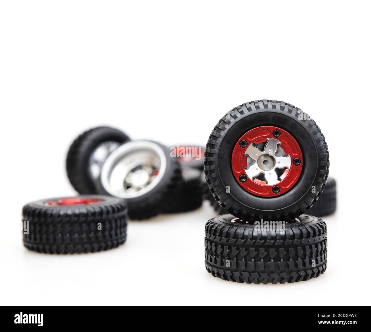 Rubber tires on red rims on a white background Stock Photo - Alamy