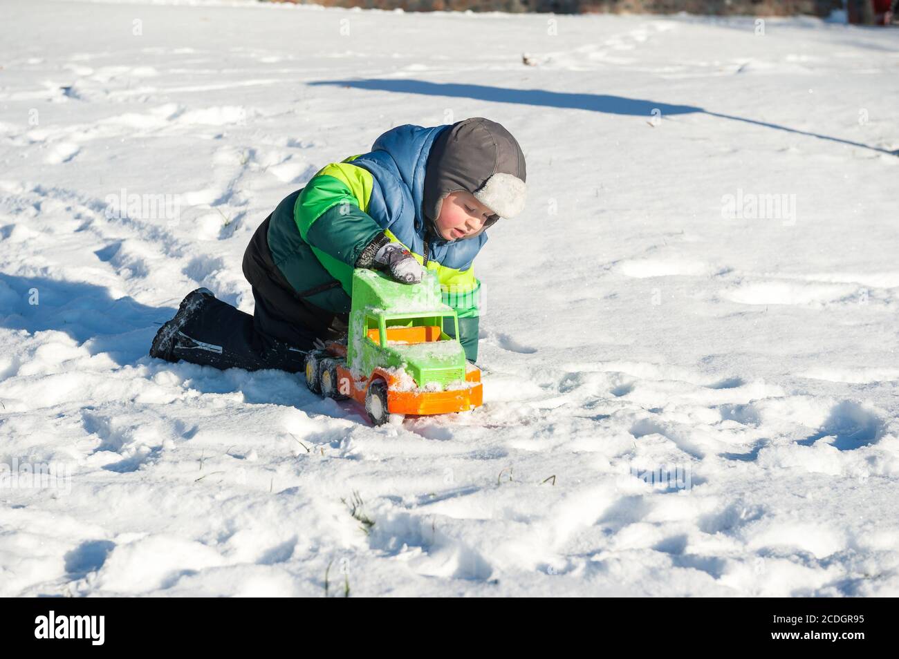 Three year old boy having fun in the snow, Zalesie, Warmian-Masurian Voivodeship, Poland, Europe ...