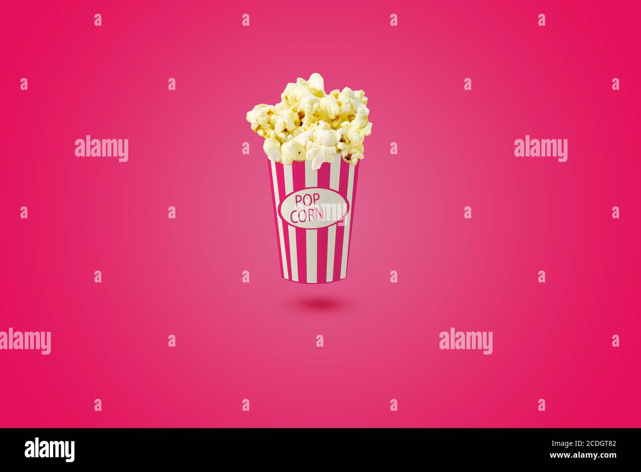 popcorn with shadow in a pink background : popcorn box : cinema concept ...