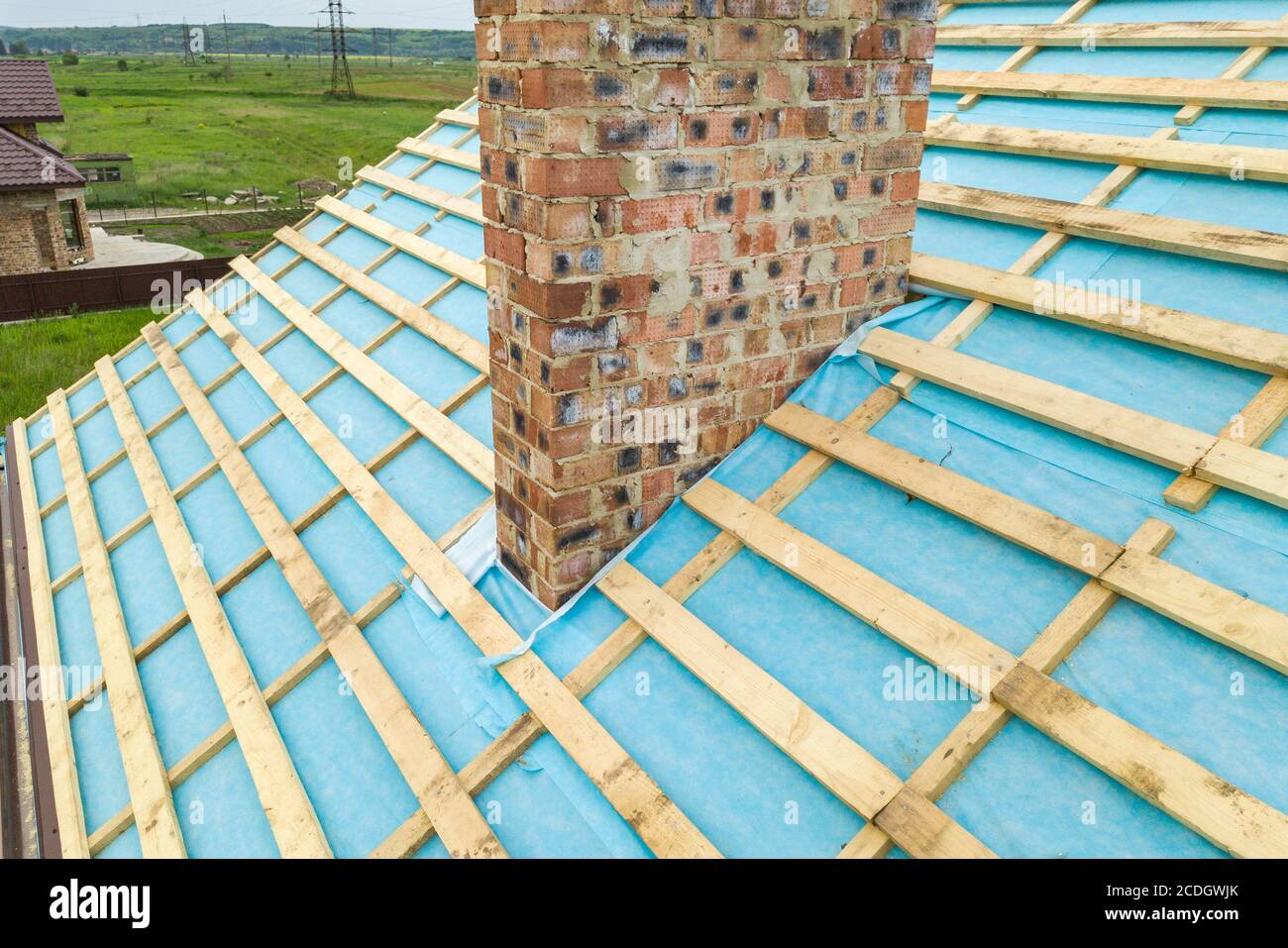 Aerial view of a wooden roof frame of brick house under construction ...