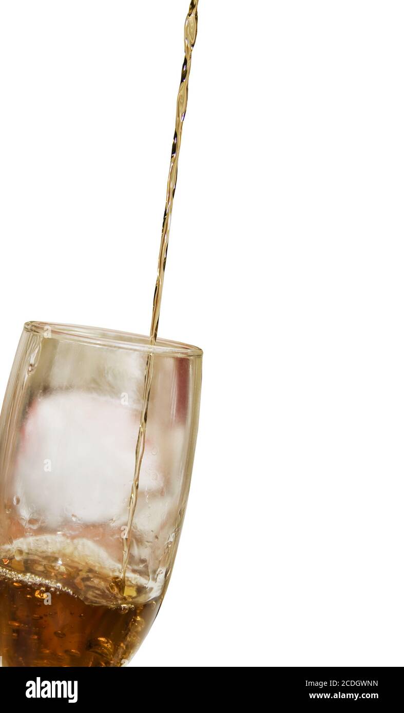Alcohol drink pours into the glass isolated over white Stock Photo - Alamy