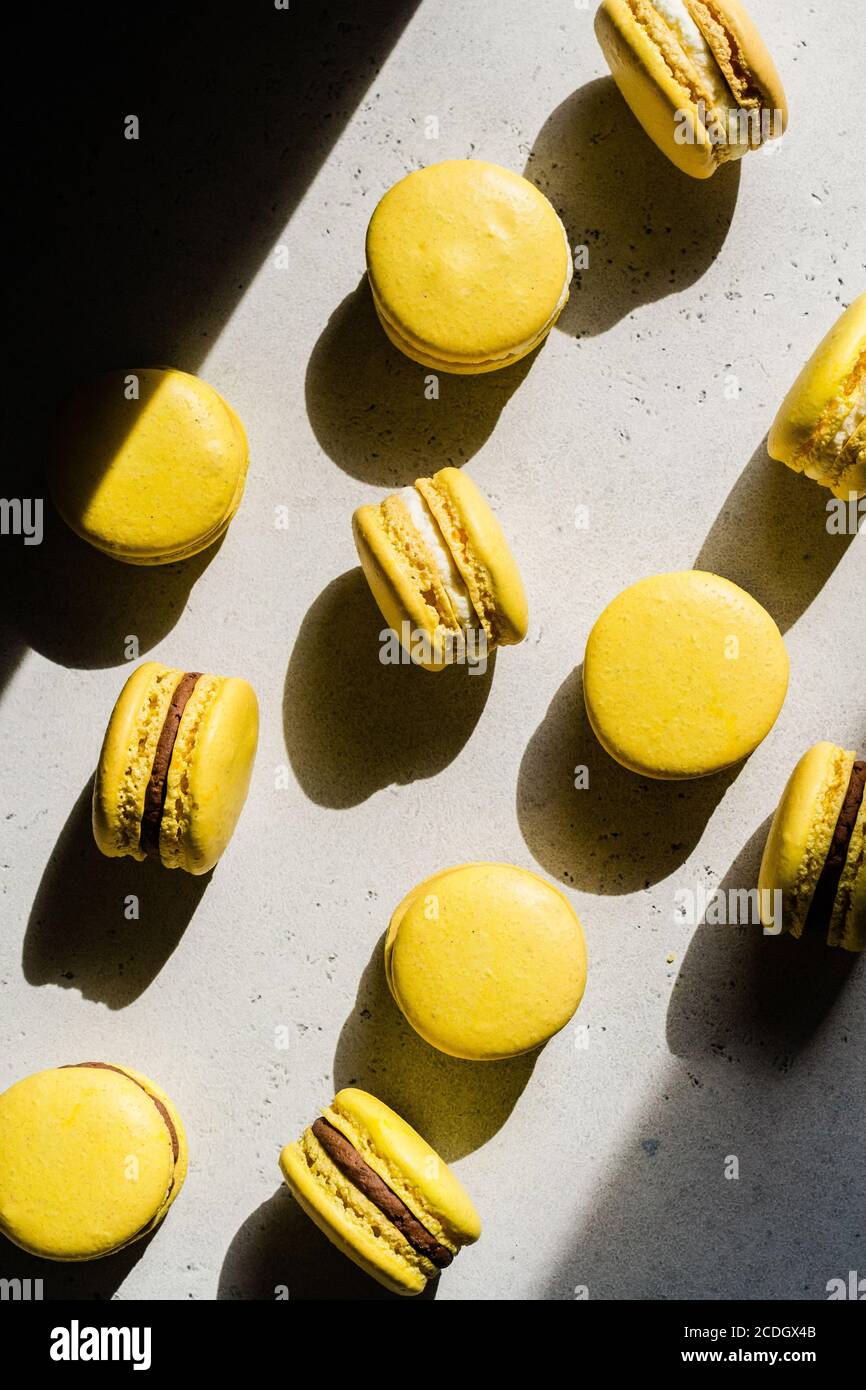 Yellow Macarons in Hard Light on White Background Stock Photo - Alamy
