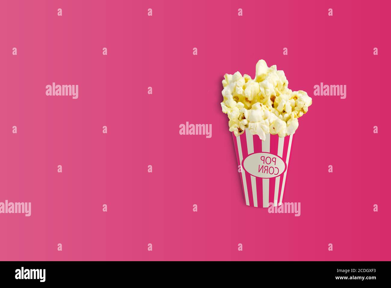 popcorn with shadow in a pink background : popcorn box : cinema concept ...