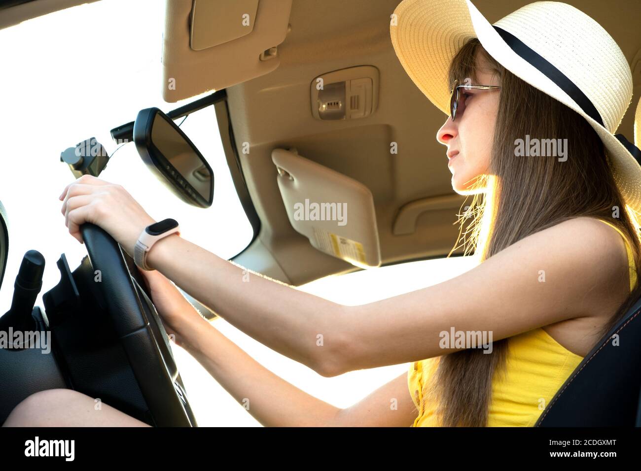 Young woman driver behind a steering wheel driving a car Stock Photo ...