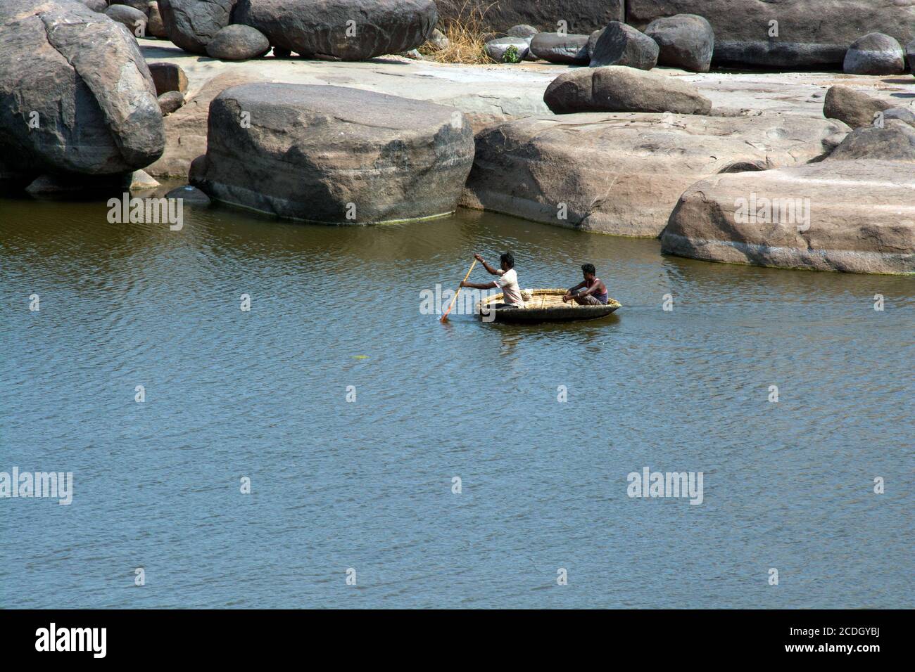 local people of hampi rides coracle (round shape boat) at tungabhadra ...