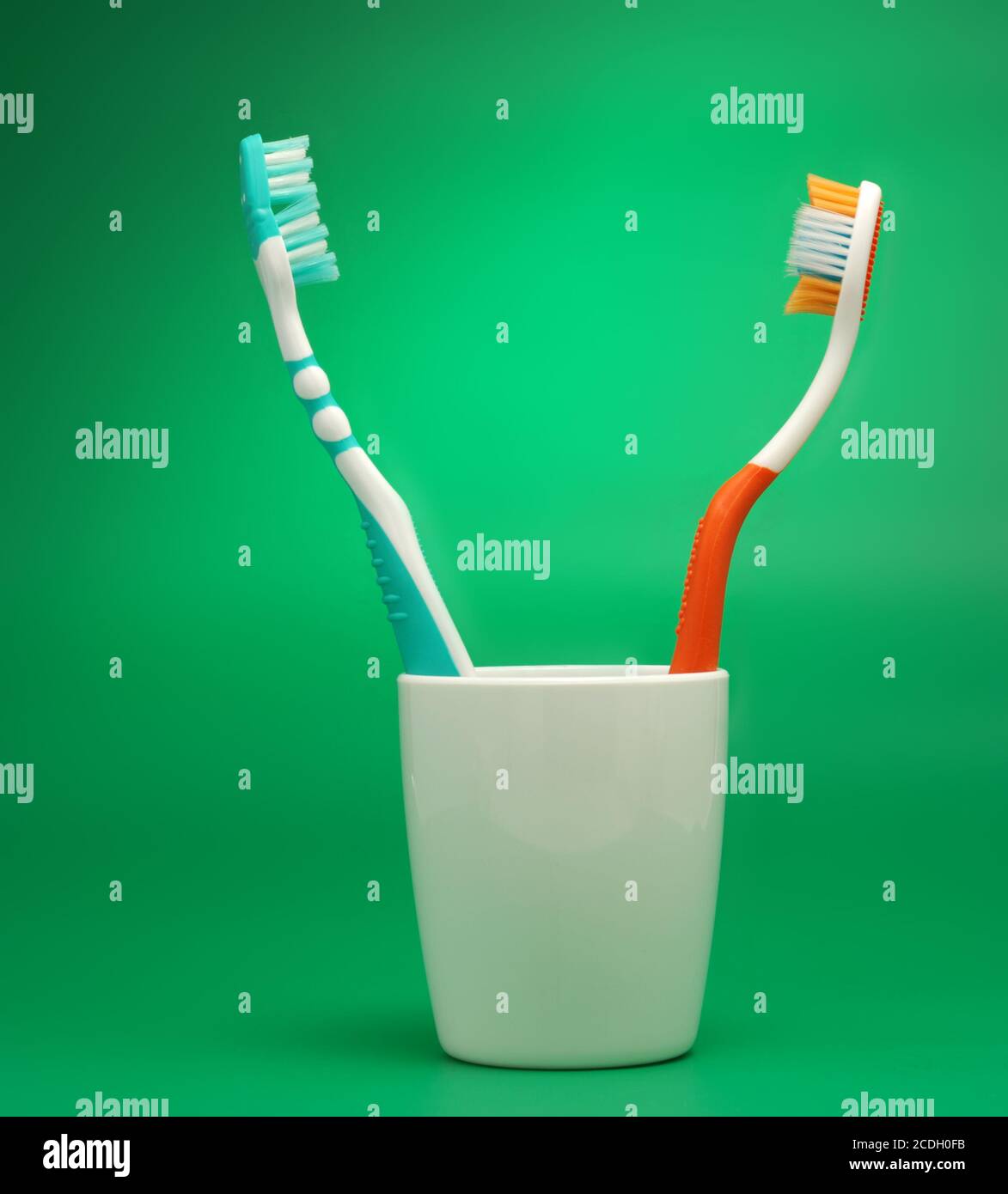 Tooth-brush green background Stock Photo - Alamy