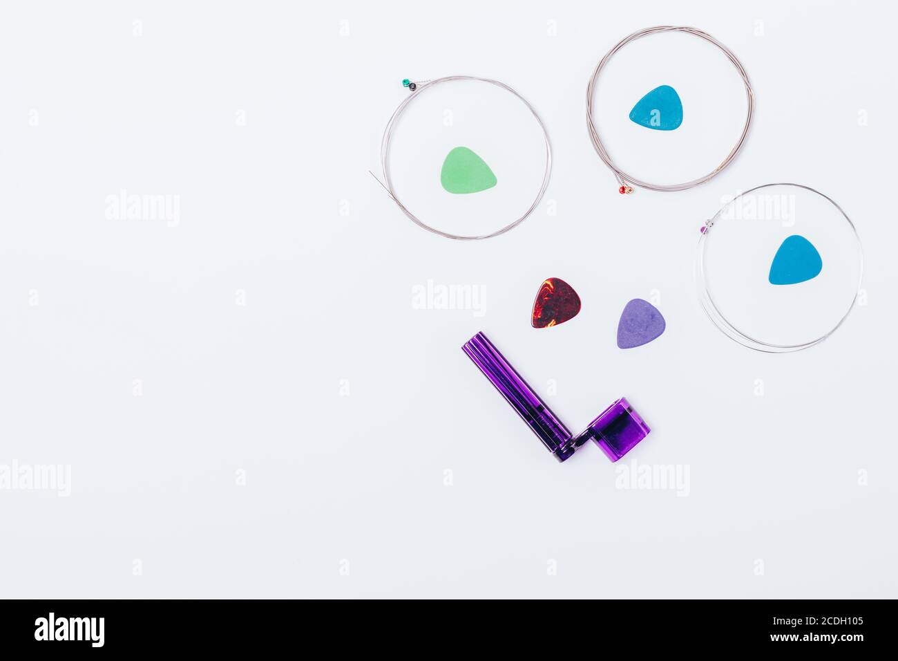 Guitar strings and picks on white background top view Stock Photo - Alamy