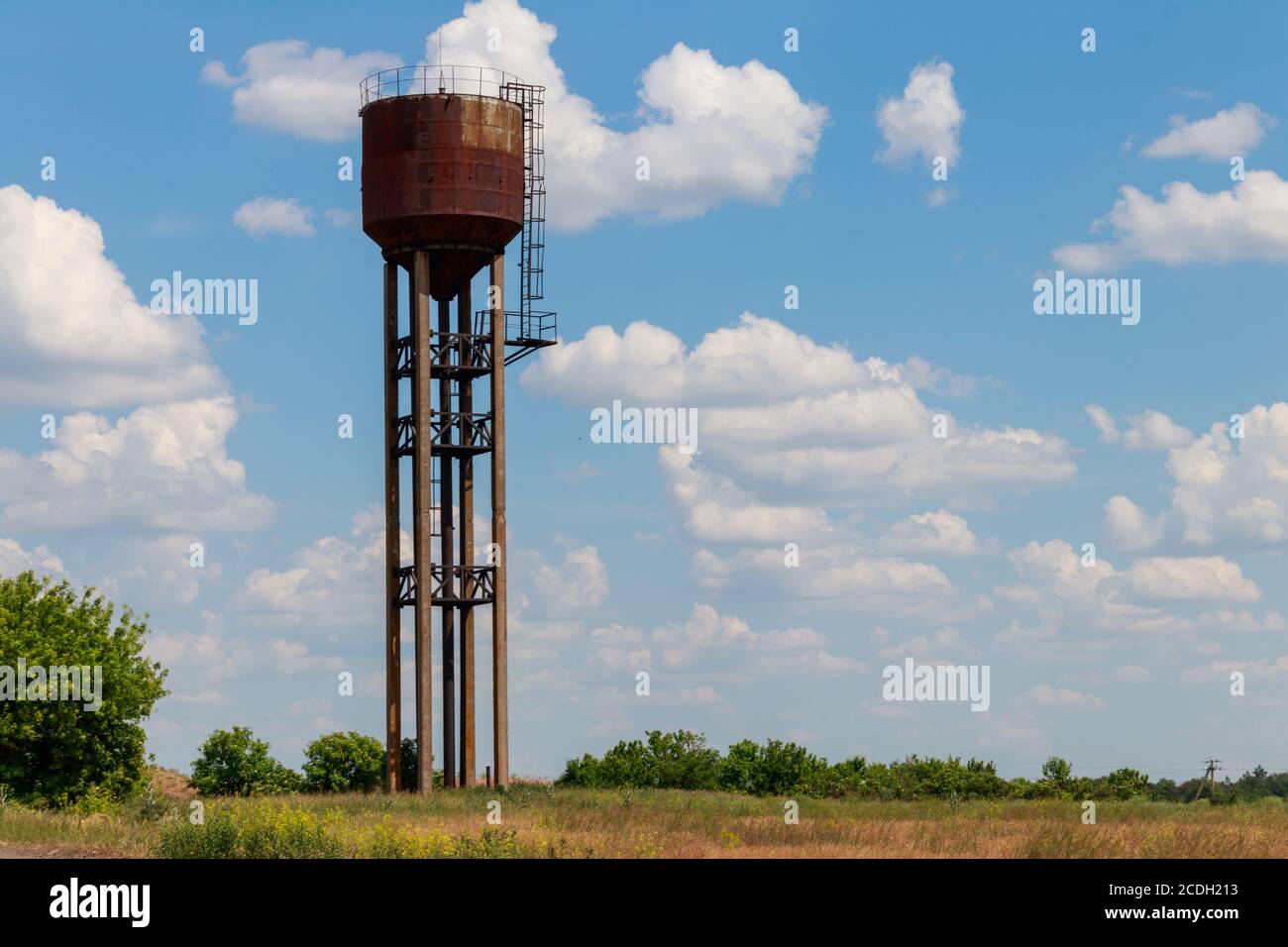 Old rusty water tower in the green field Stock Photo - Alamy