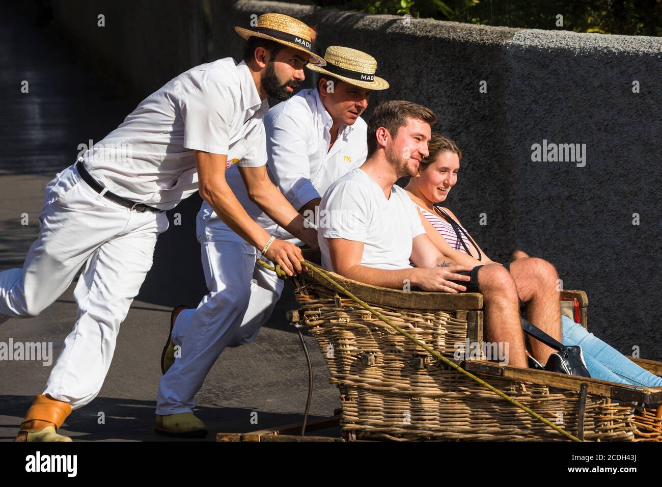 Portugal, Madeira, Funchal, Tourists on the traditional wicker basket ...