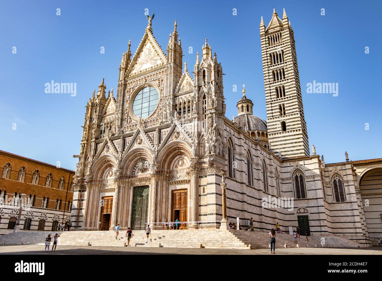 People walk in front of the dome of Siena near Florence Stock Photo - Alamy