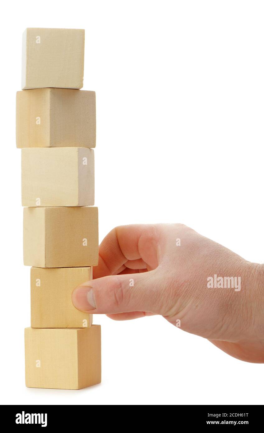 The hand establishes a wooden cube Stock Photo - Alamy