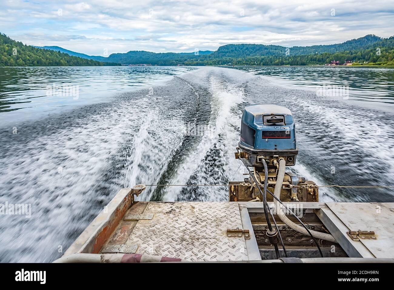 view of the engine on the motor boat from behind and the water trail ...