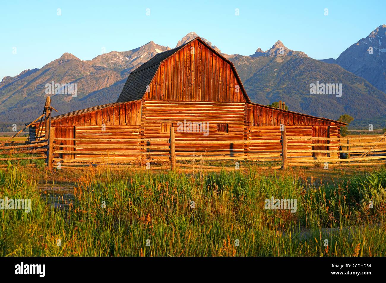 Sunrise over a log cabin on Mormon Row Historic District in Antelope ...