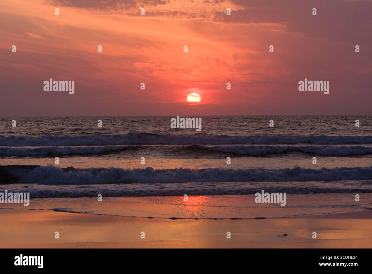 Colorful clouds and waves on the beach at sunset in Mazatlan, Mexico ...