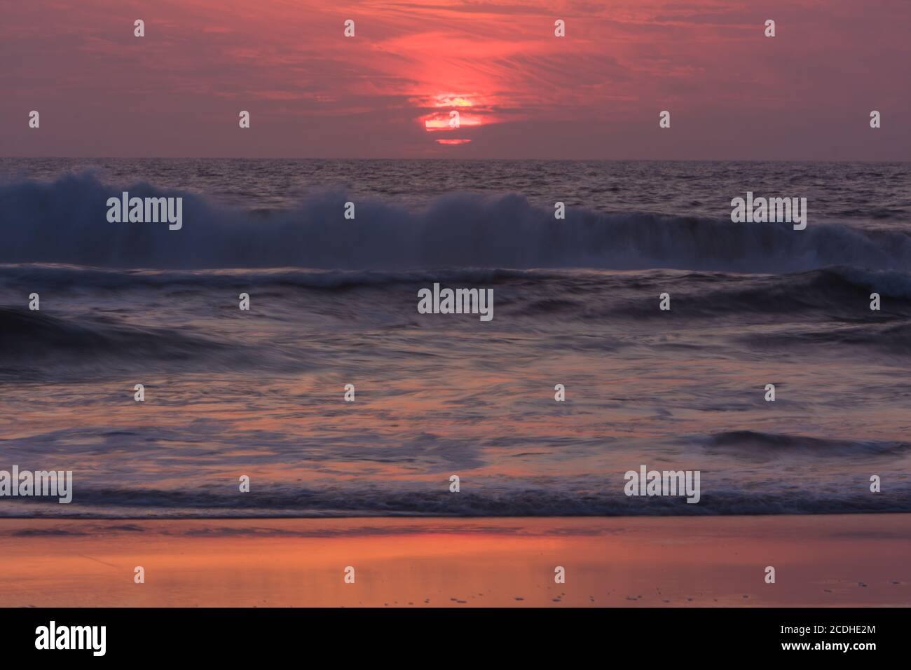 Colorful clouds and waves on the beach at sunset in Mazatlan, Mexico ...