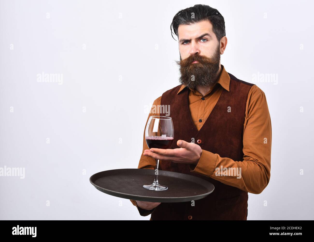 Man with beard and mustache holds alcohol on white background. Barman ...