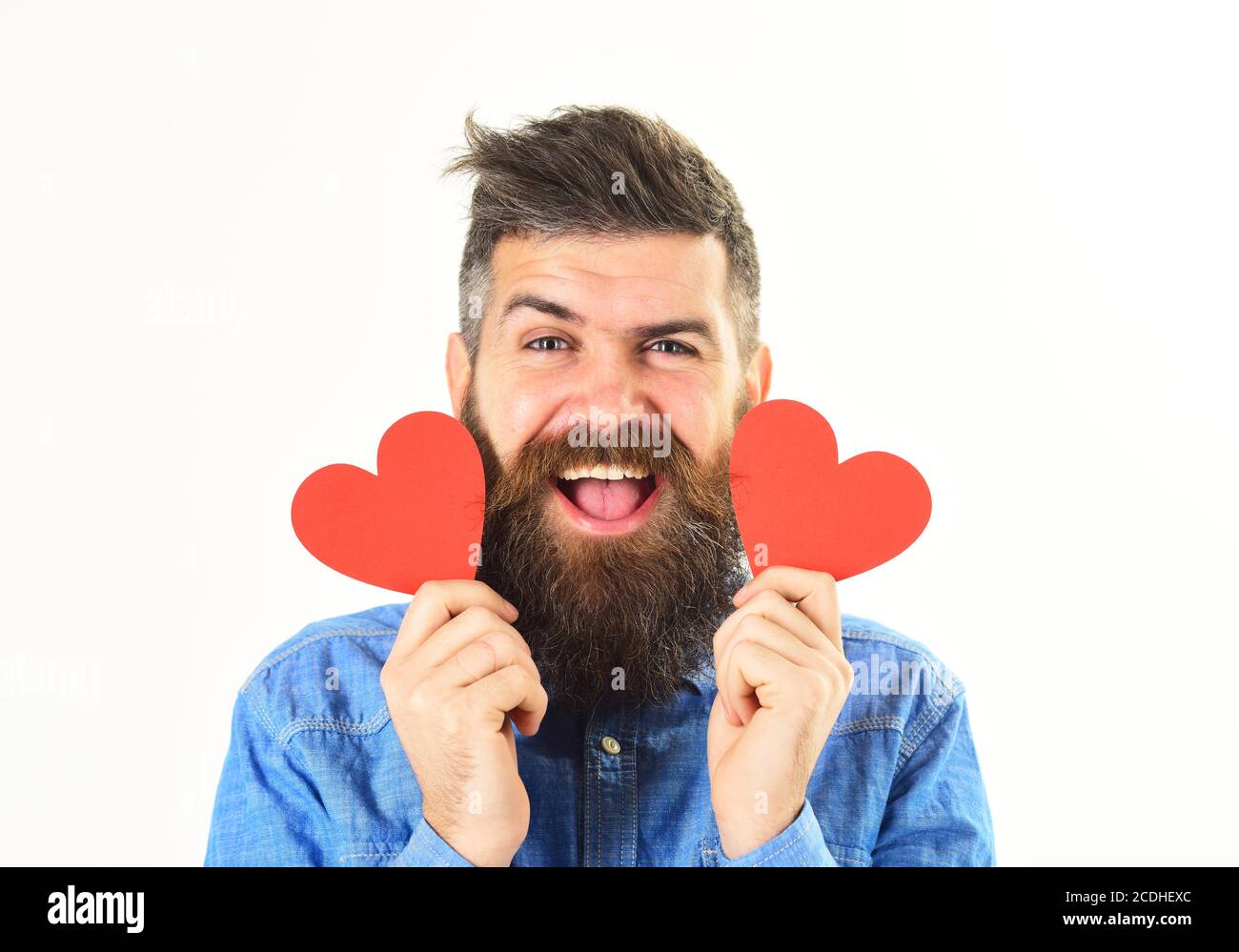 Man with beard with happy face holds red hearts or valentine cards ...