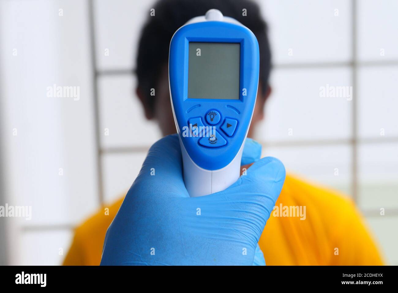 Hand holding infrared thermometer to measuring temperature Stock Photo ...
