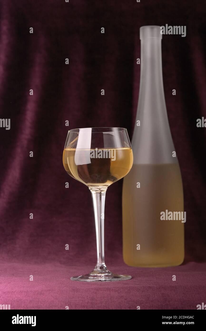 Glass and bottle of white wine Stock Photo - Alamy