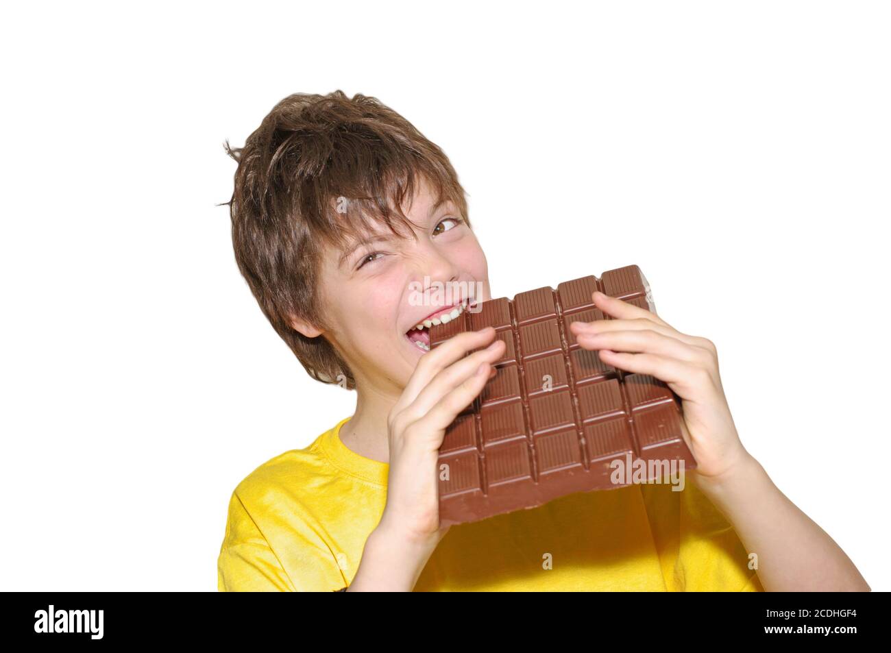 Happy young man eating chocolate Stock Photo - Alamy