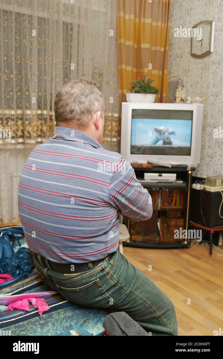 A man watching screen of his television Stock Photo - Alamy