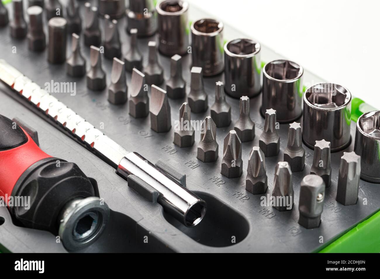 Tool box with attachments and bits of different shapes and sizes close ...