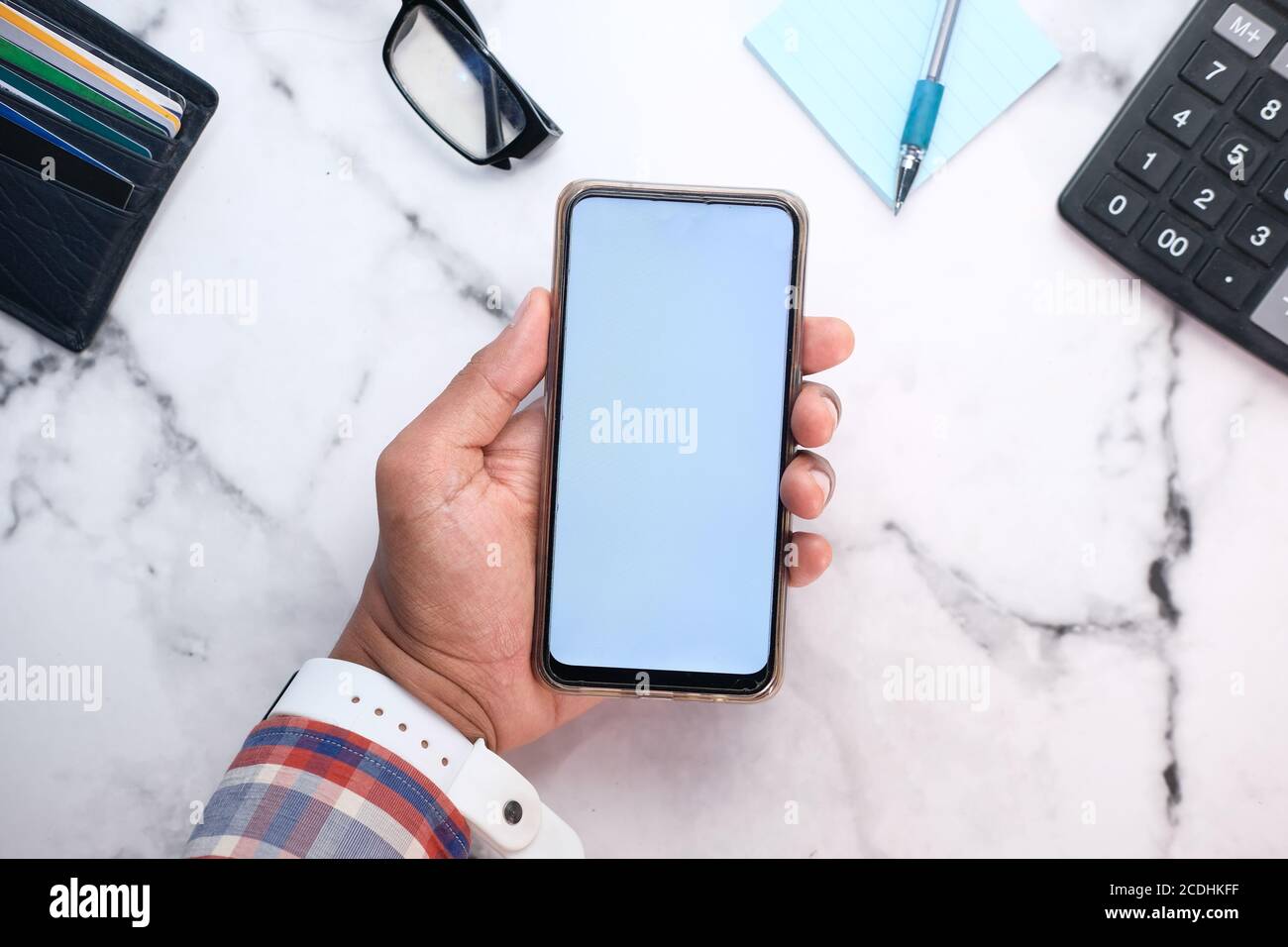 flat composition of hand holding smart phone on white background Stock ...