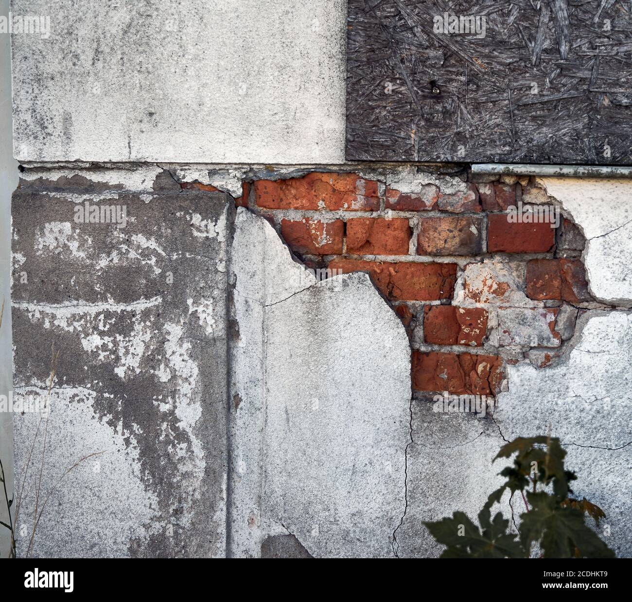 Detail of a demolition house with chipped plaster and recognizable red ...