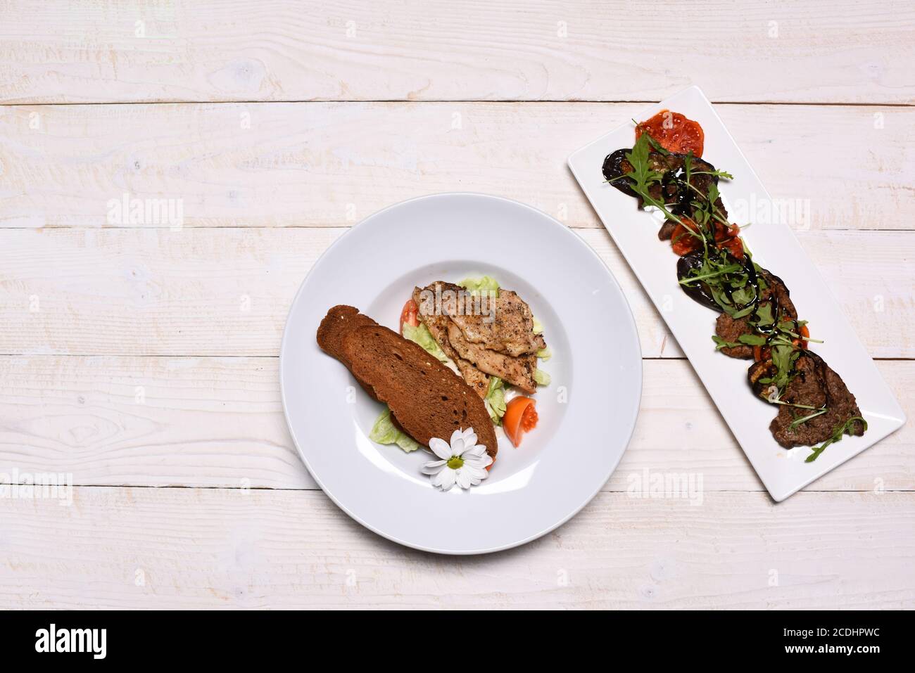 Main meal with bread on white wooden background. Main course and ...