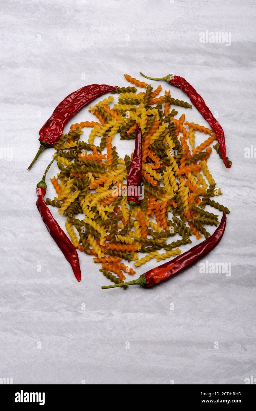 delicious colorful Italian pasta with chili pepper on grey textured ...