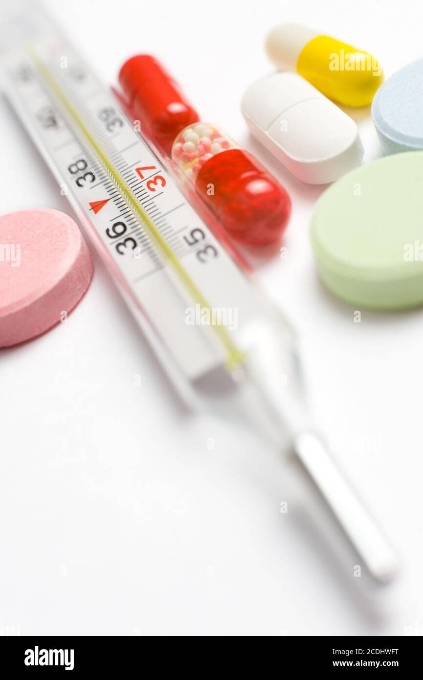 thermometer and pills Stock Photo - Alamy