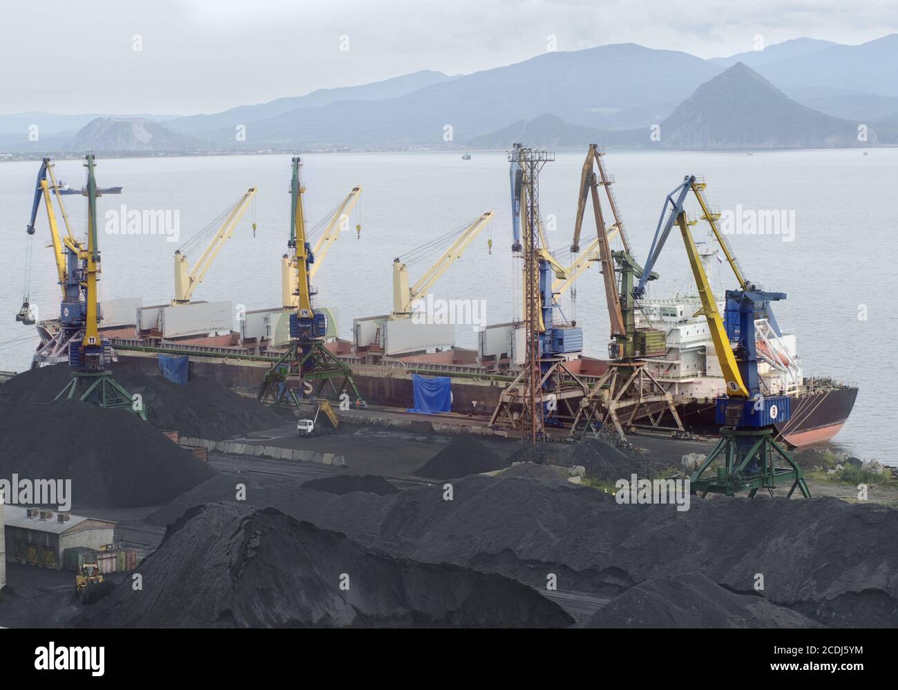 Vessel under loading Stock Photo - Alamy