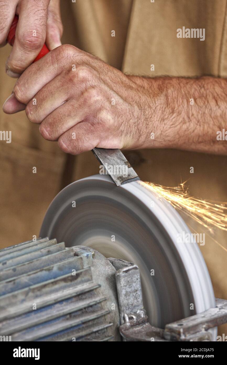 manual worker sharp his tool Stock Photo - Alamy