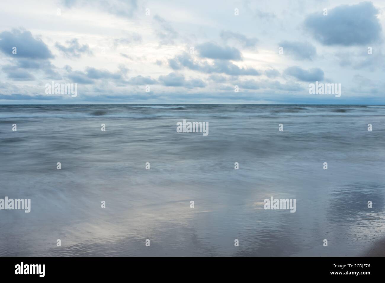 Blue sky with clouds over ocean waves with sand hi-res stock ...