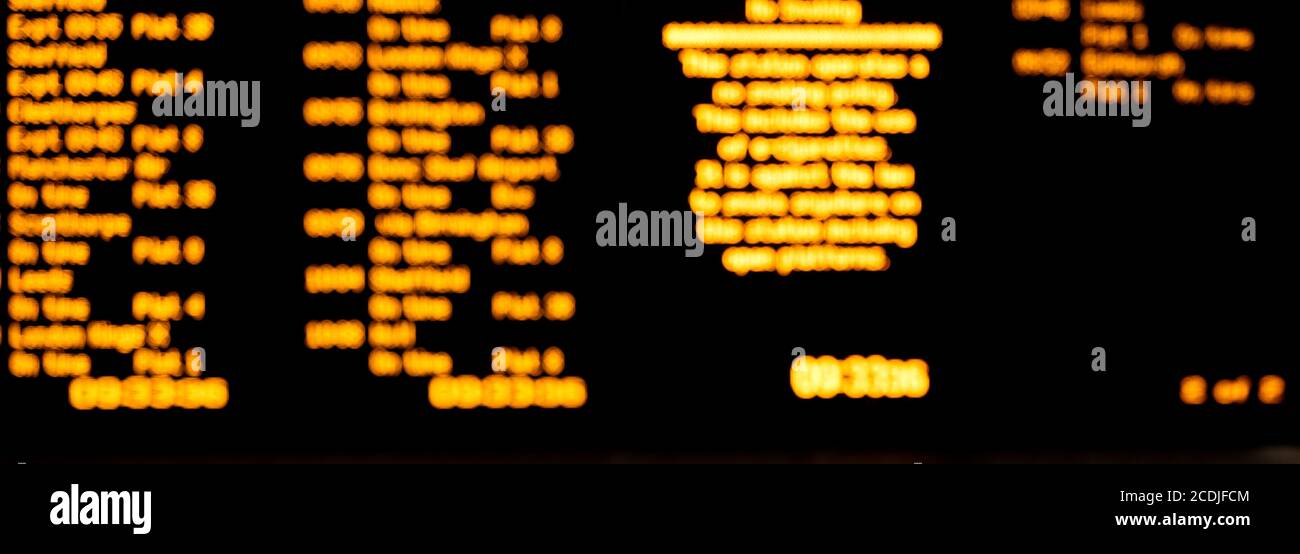 blurred led train schedule text on black background Stock Photo - Alamy