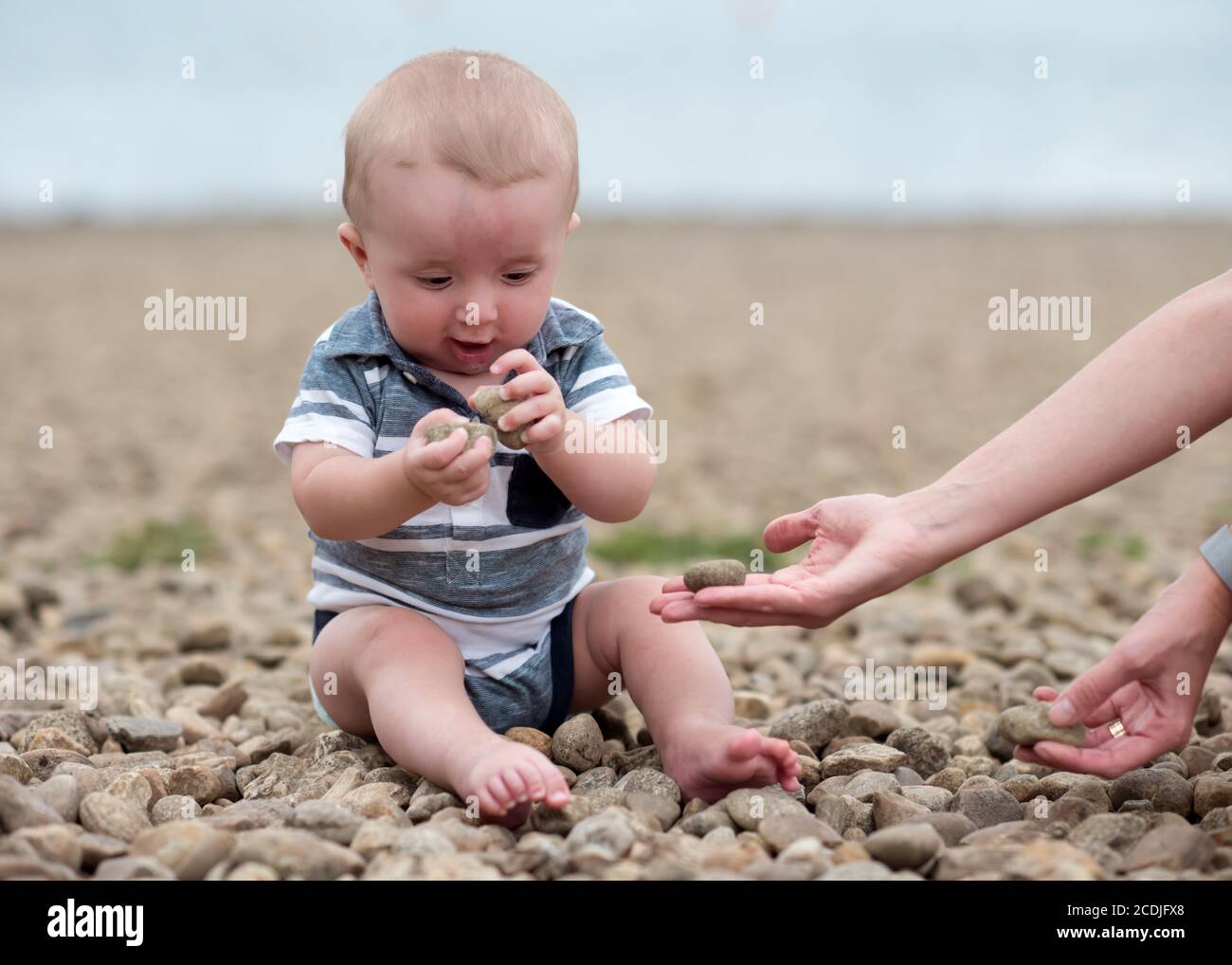 Child playing with stones hi-res stock photography and images - Alamy