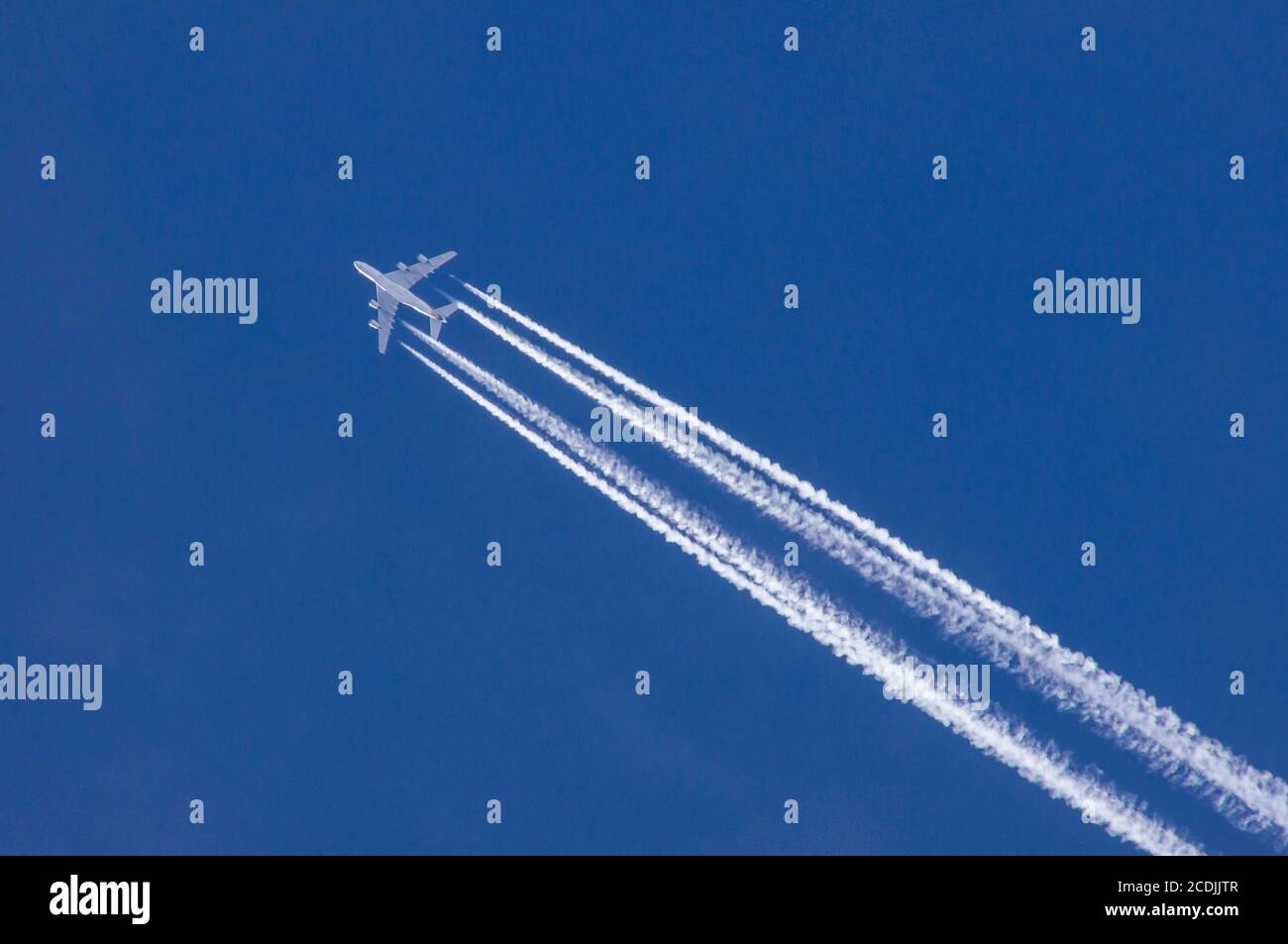 Airliner with jet trails Stock Photo - Alamy