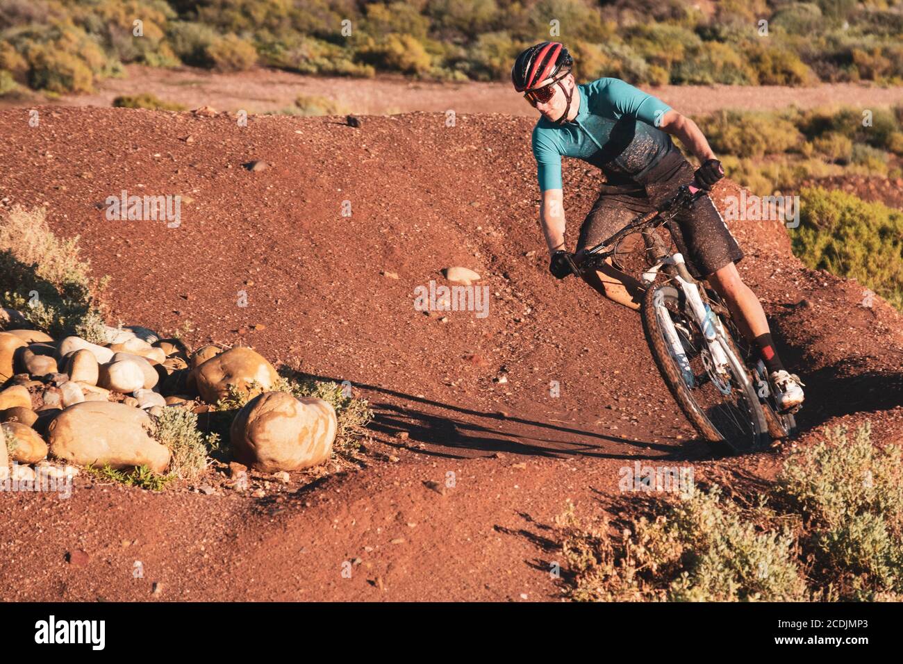 mountain biker riding around a banked corner on a single track Stock ...