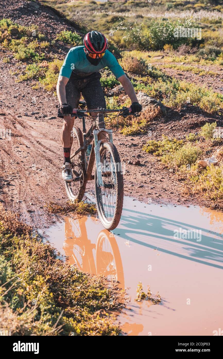 Riding a bike through a puddle hi-res stock photography and images - Alamy