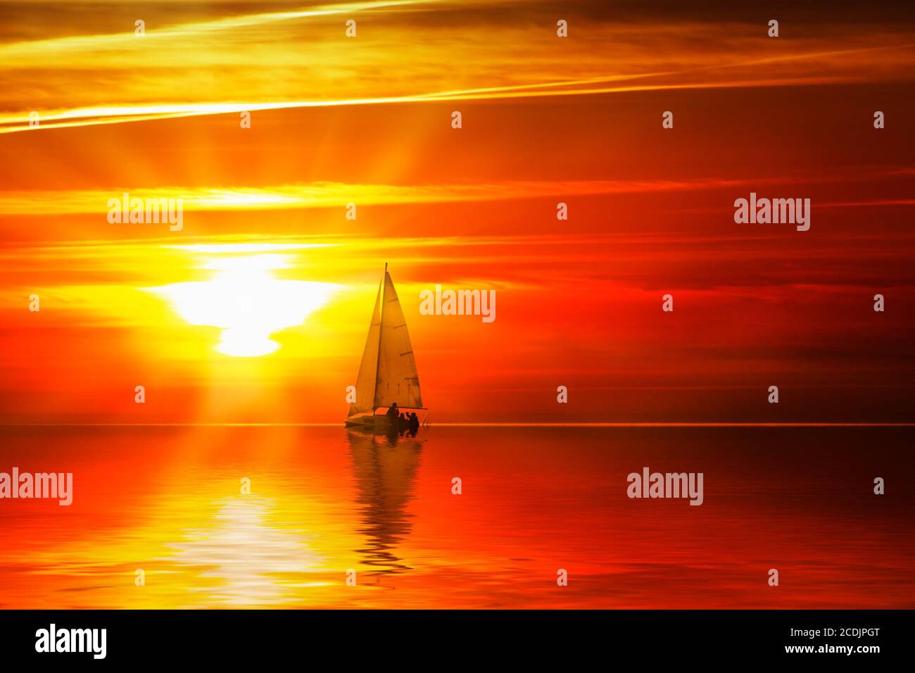 Sailboat on the ocean at sunset Stock Photo - Alamy