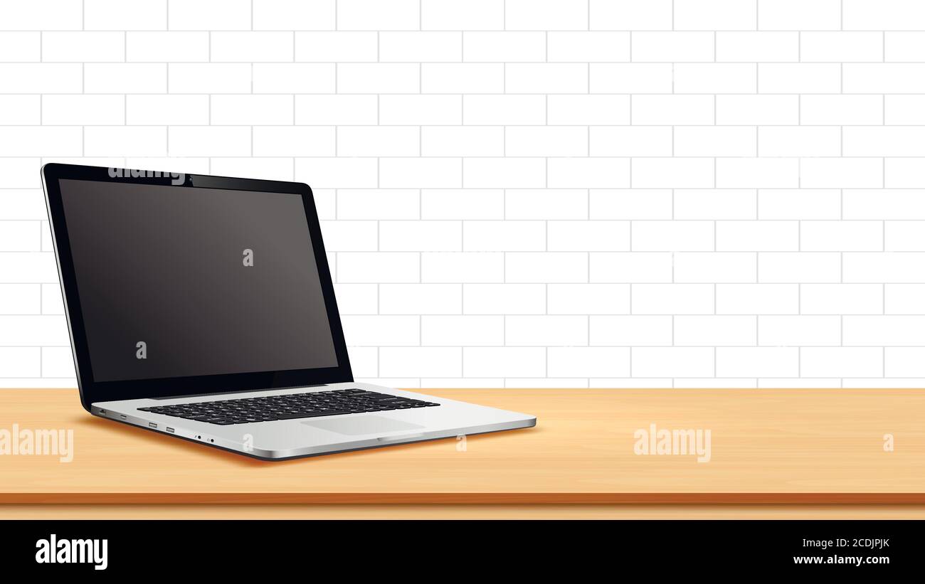 Modern laptop with blank screen on table against brick wall Stock ...