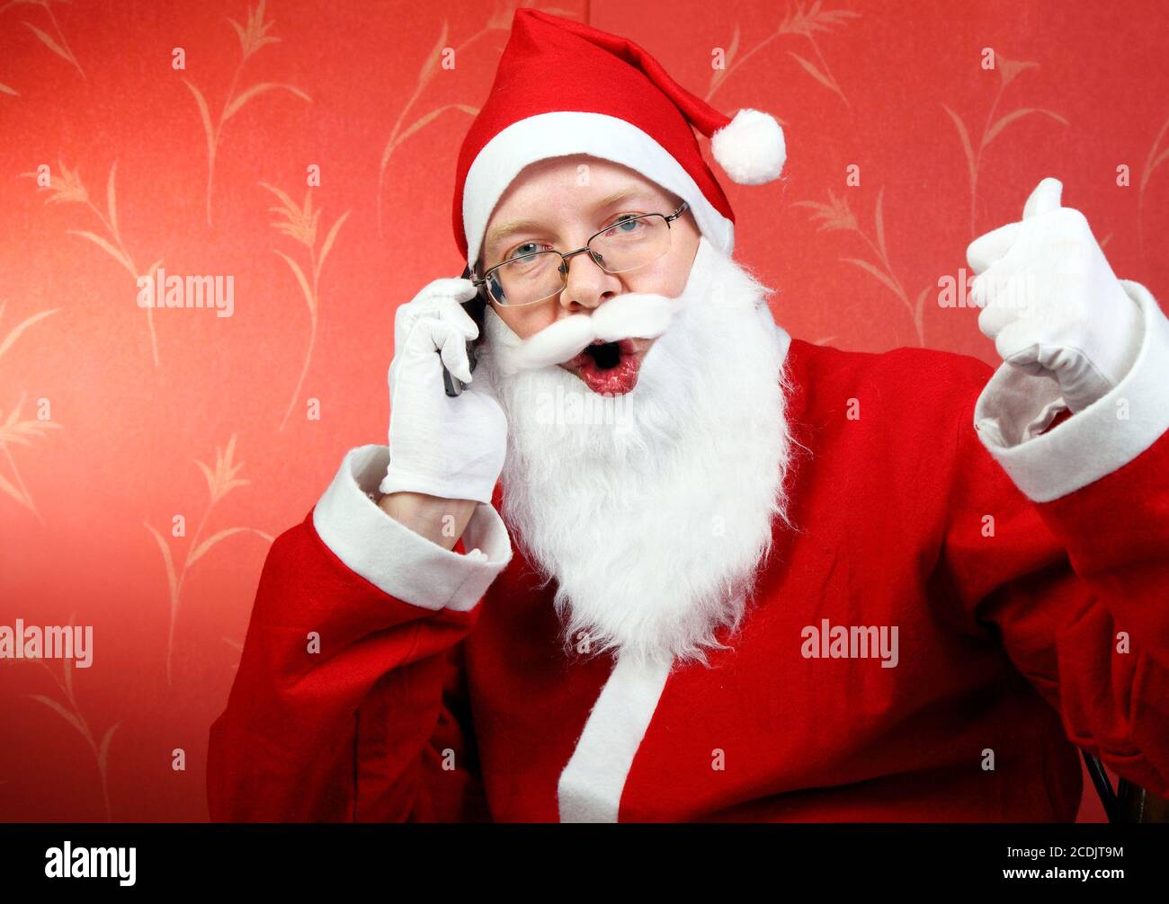 happy santa claus with phone Stock Photo - Alamy