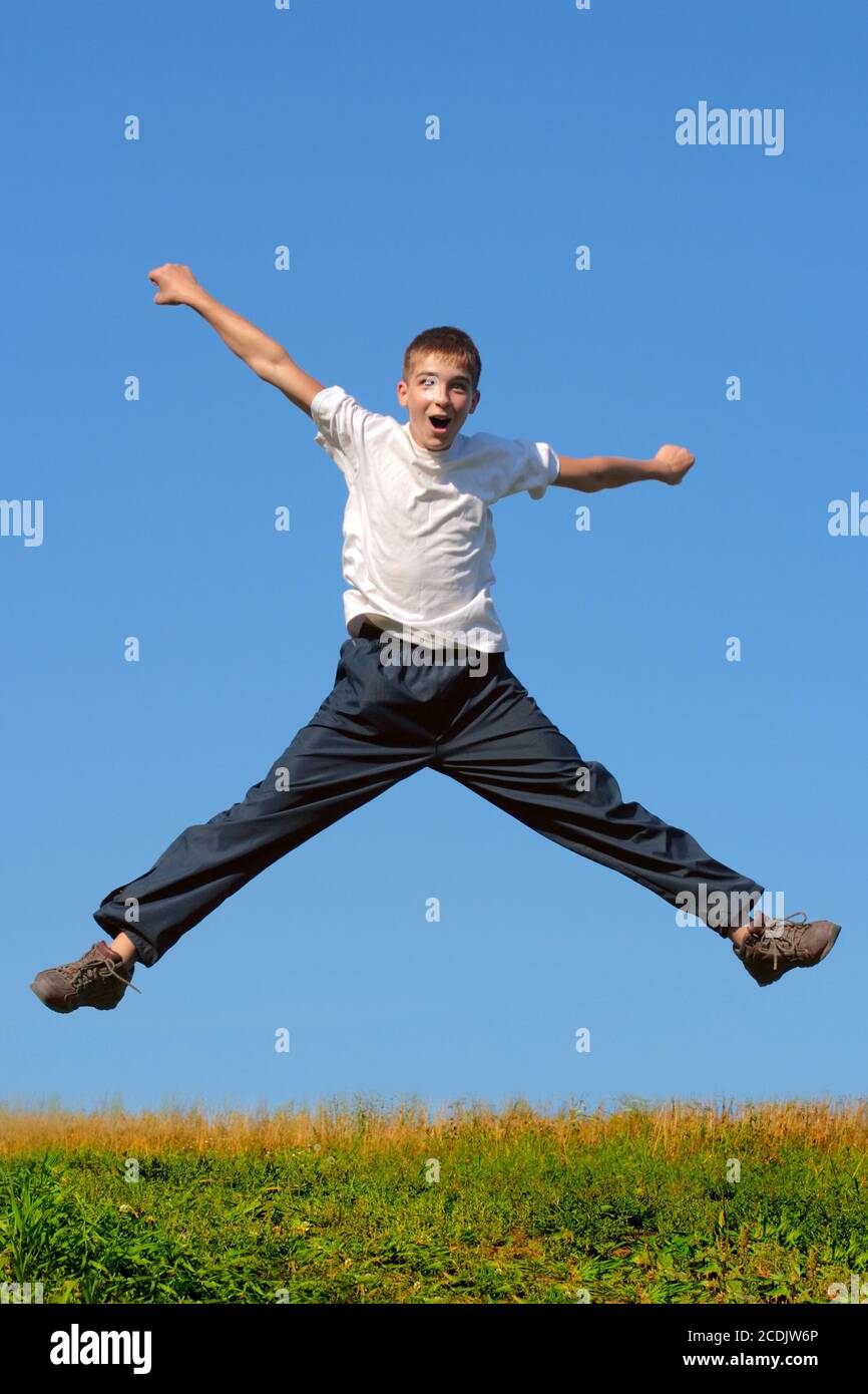 Happy boy jumping Stock Photo - Alamy