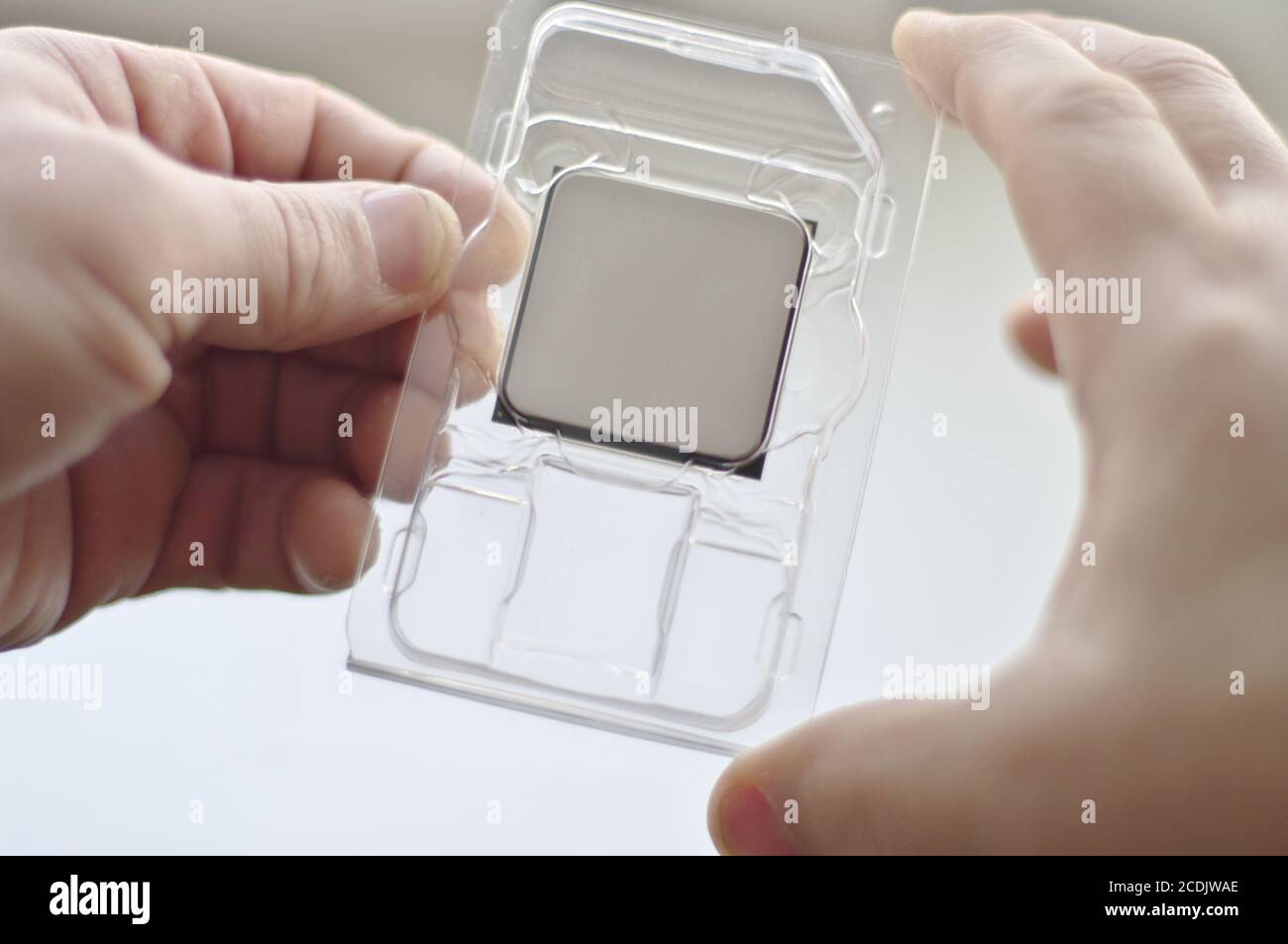 Male hands holding dual core CPU Stock Photo - Alamy